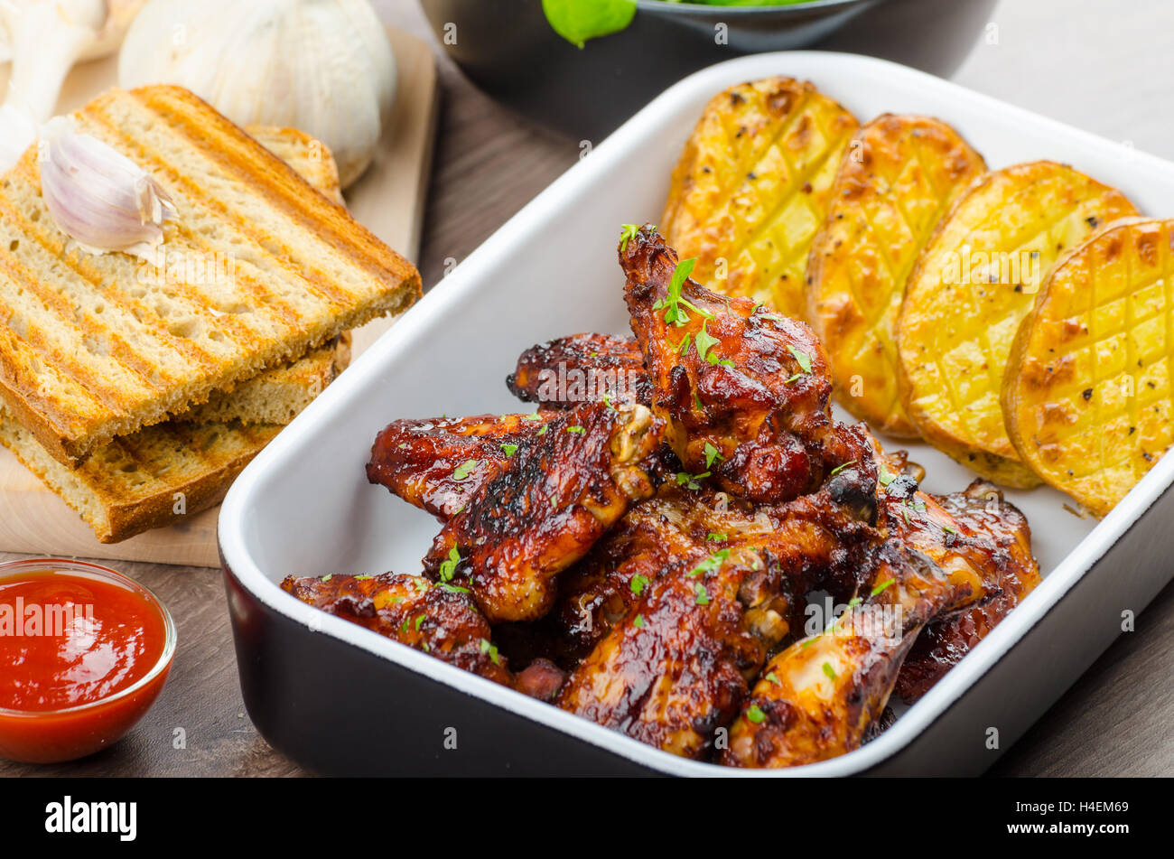 Sticky chicken wings with garlic bread panini, rustic spicy potatoes ...