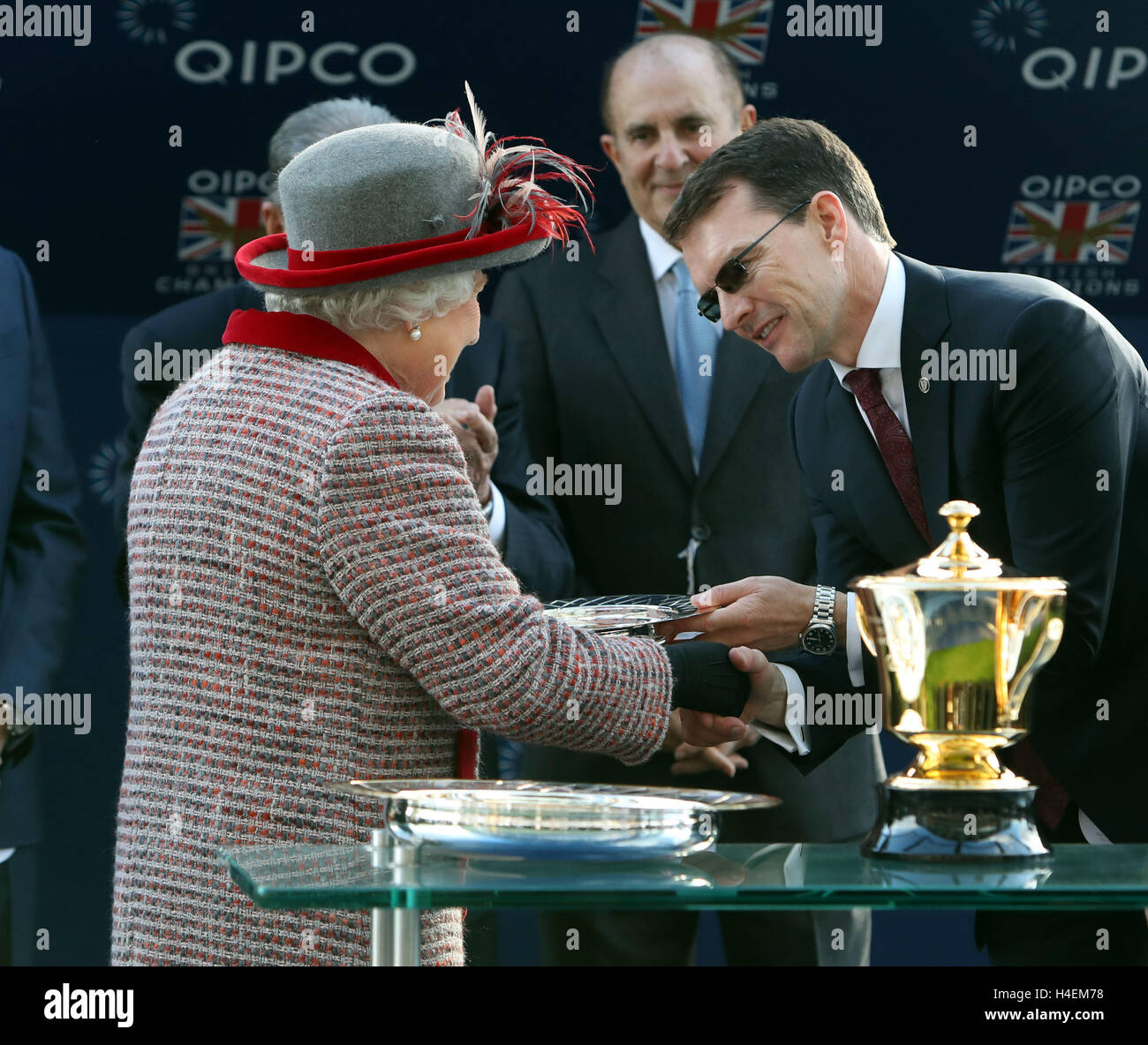 Queen Elizabeth II presents the trophy to the winning trainer of ...
