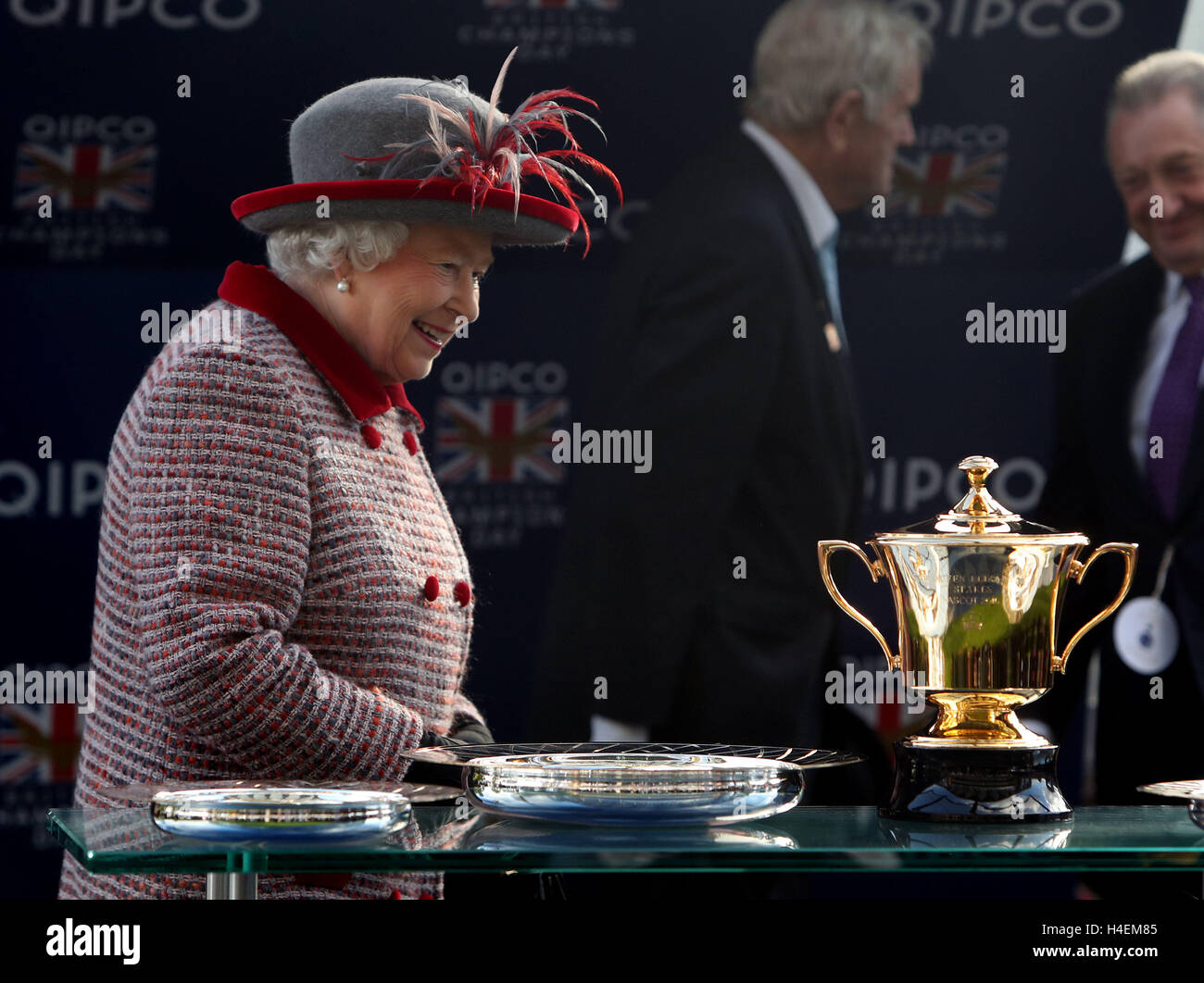 Queen Elizabeth II presents the trophy to the winning trainer of ...