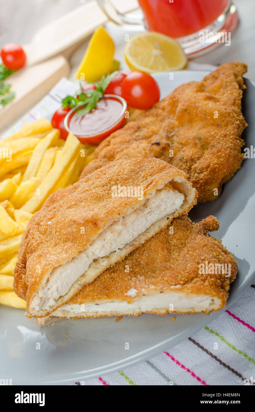Schnitzel with french fries and a spicy dip, fresh from red orange ...