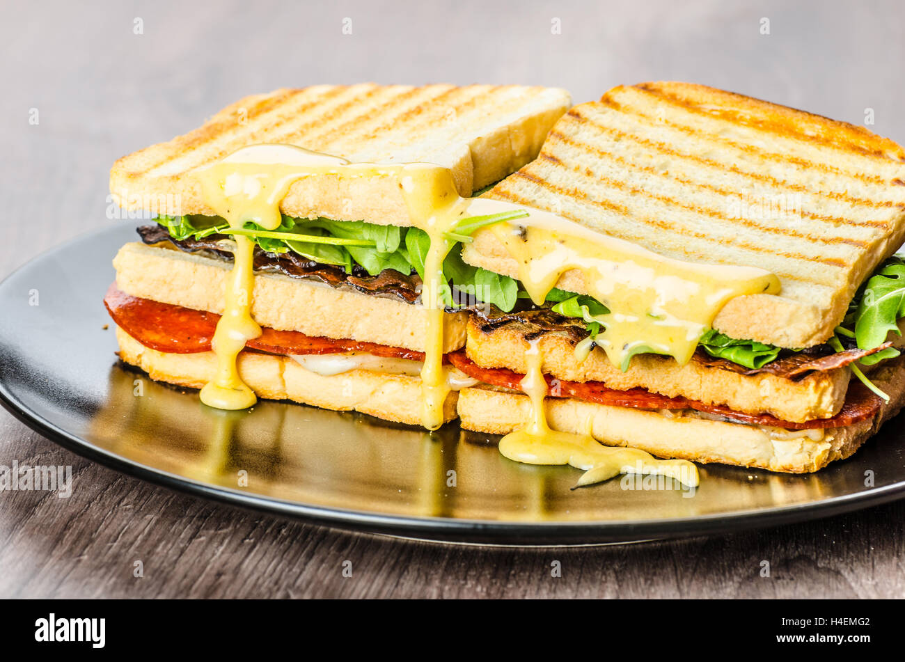 Three floor Panini toast with bacon, arugula, pepperoni salami and ...