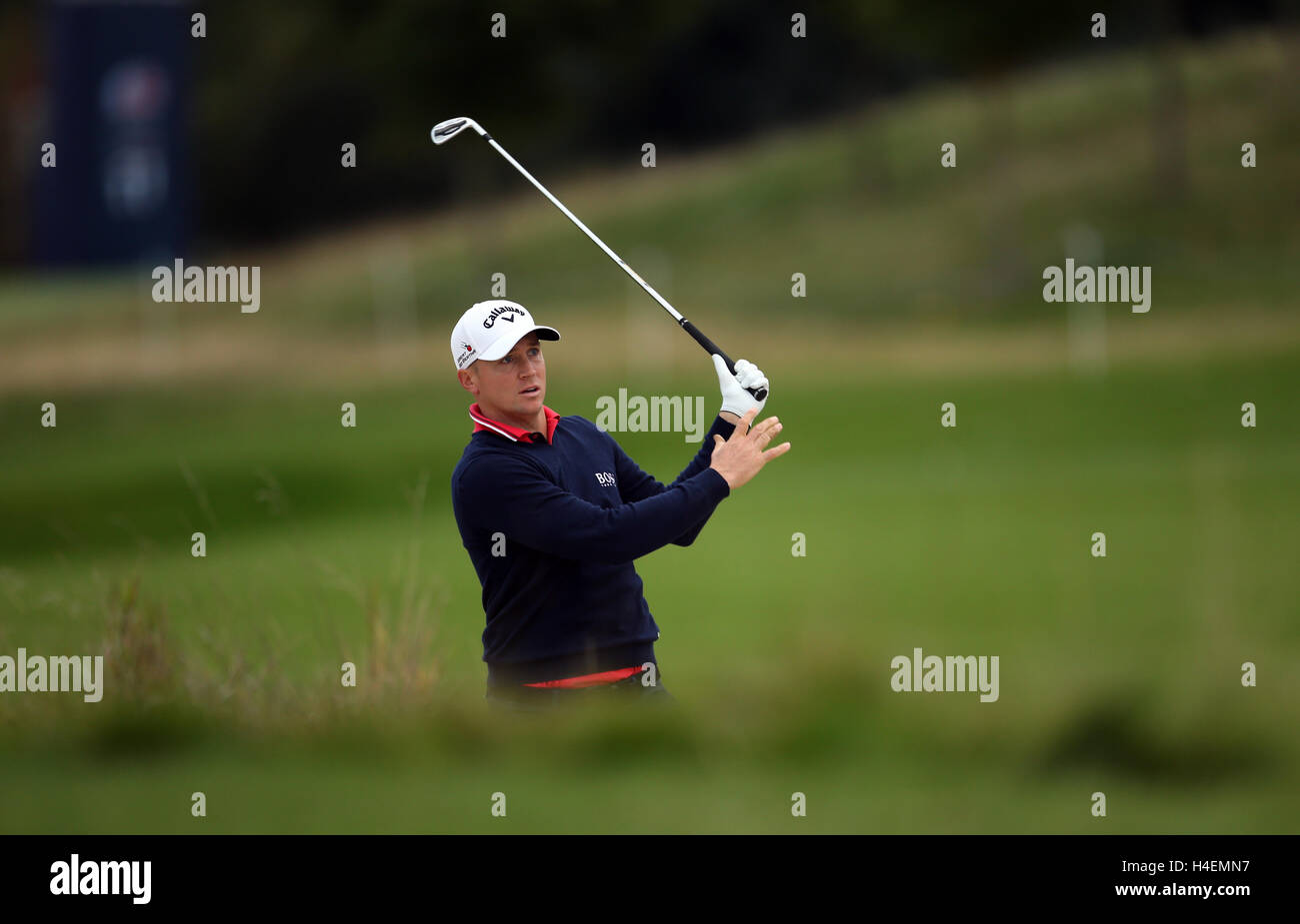 Sweden's Alex Noren watches his shot from the bunker on the 18th hole ...
