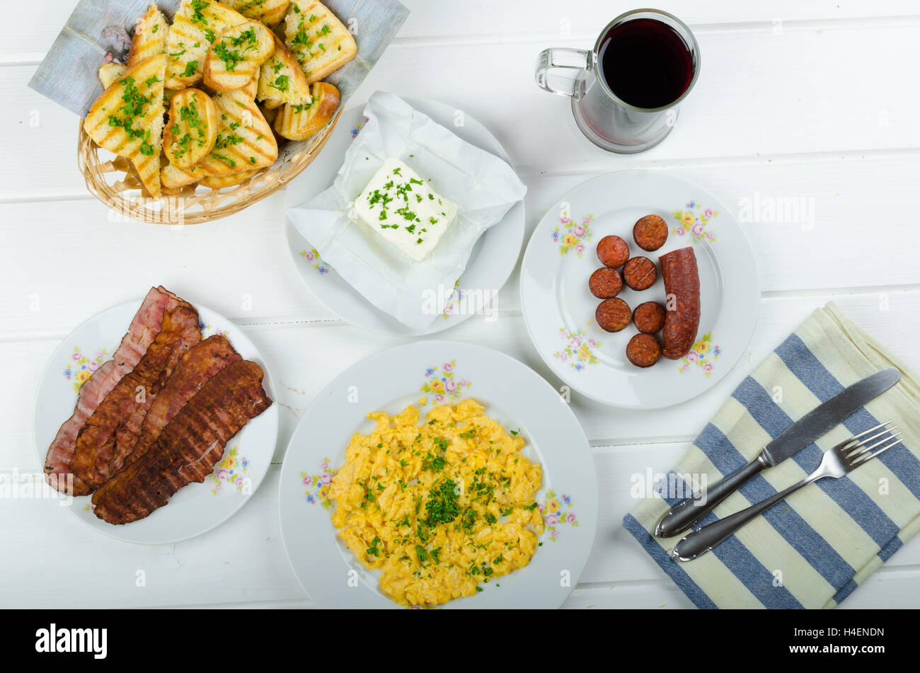 A hearty breakfast of eggs, bacon, sausage and toasted baguette and ...