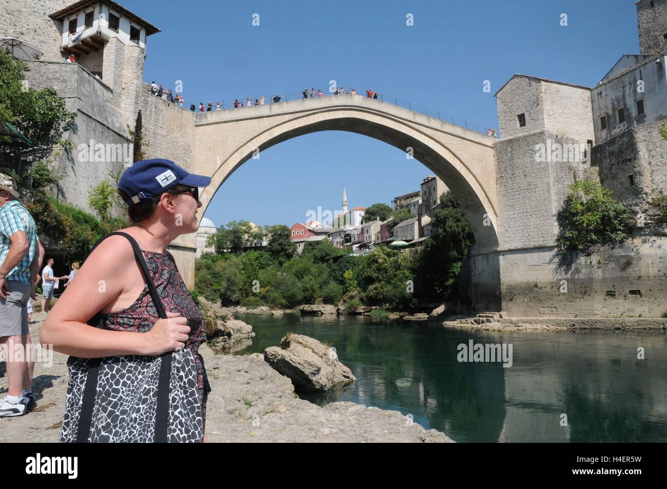 A tourist admires the Stari Most bridge in Bosnia Herzegovina Stock ...
