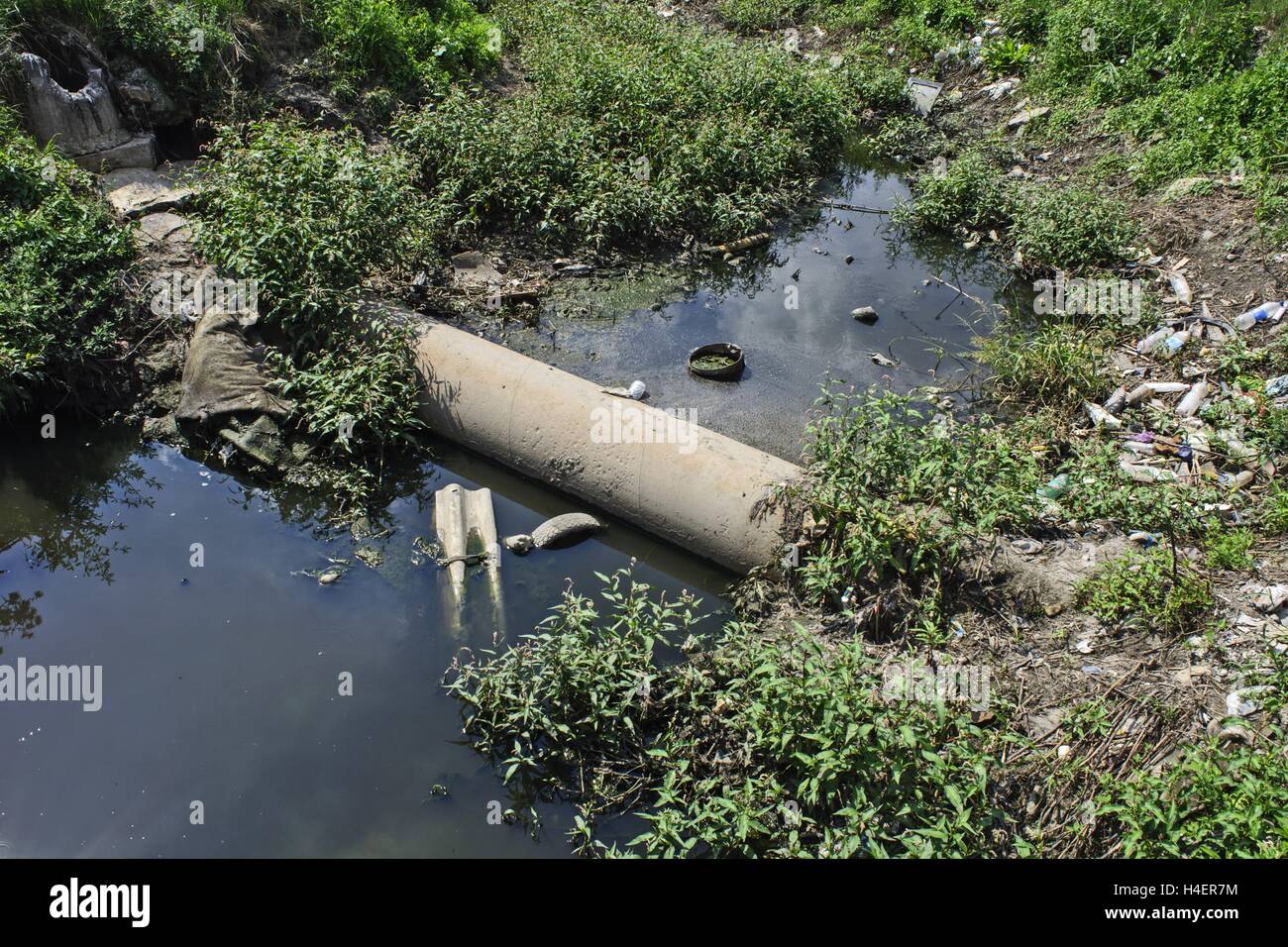 Very polluted river that runs through the village Stock Photo - Alamy