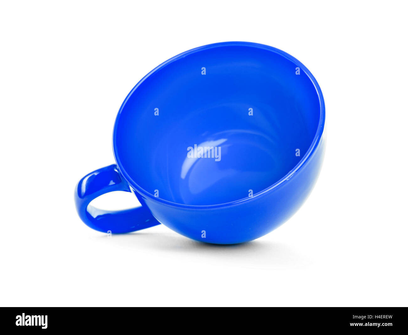 Blue cup lies on a white background Stock Photo - Alamy