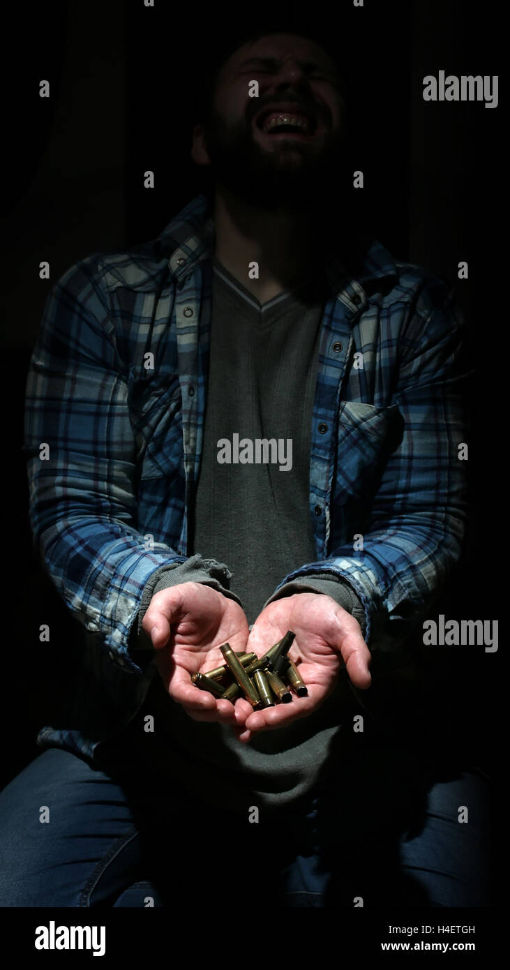 bullet in hands man Stock Photo - Alamy
