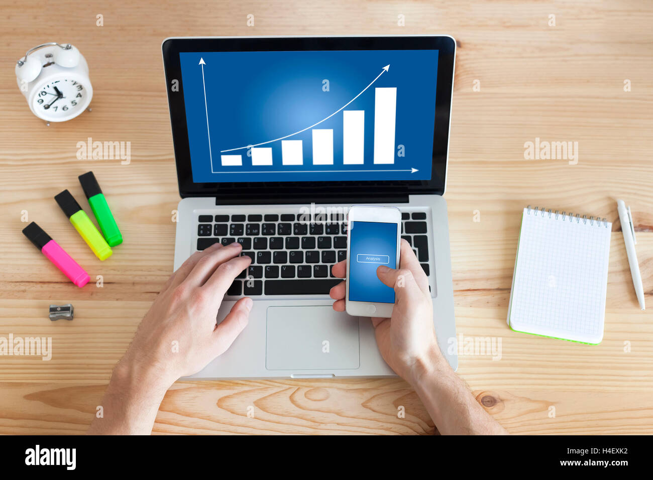 Working at home on business charts with laptop and smartphone Stock ...