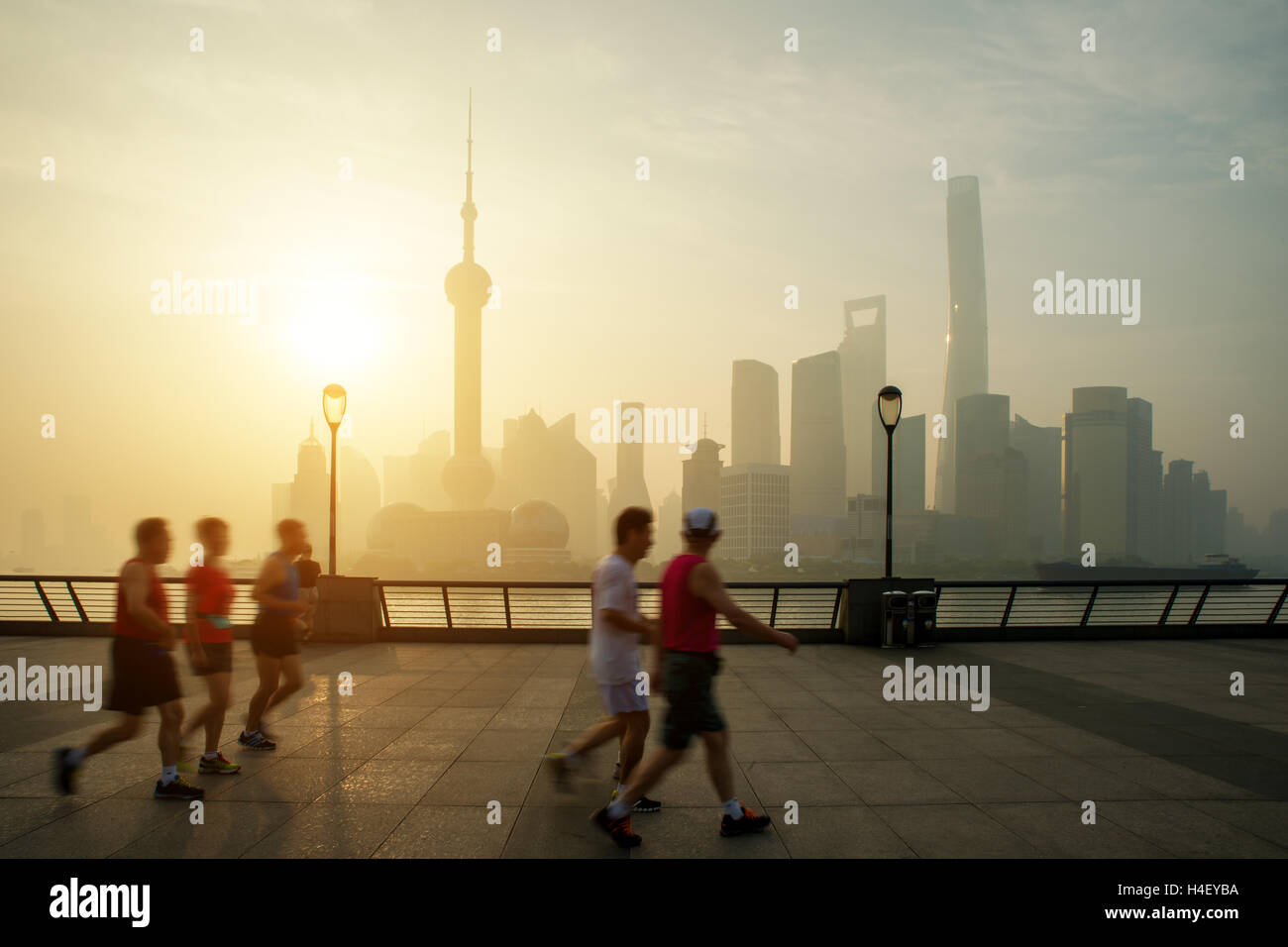 People running in morning at Huangpu River riverside with Shanghai ...