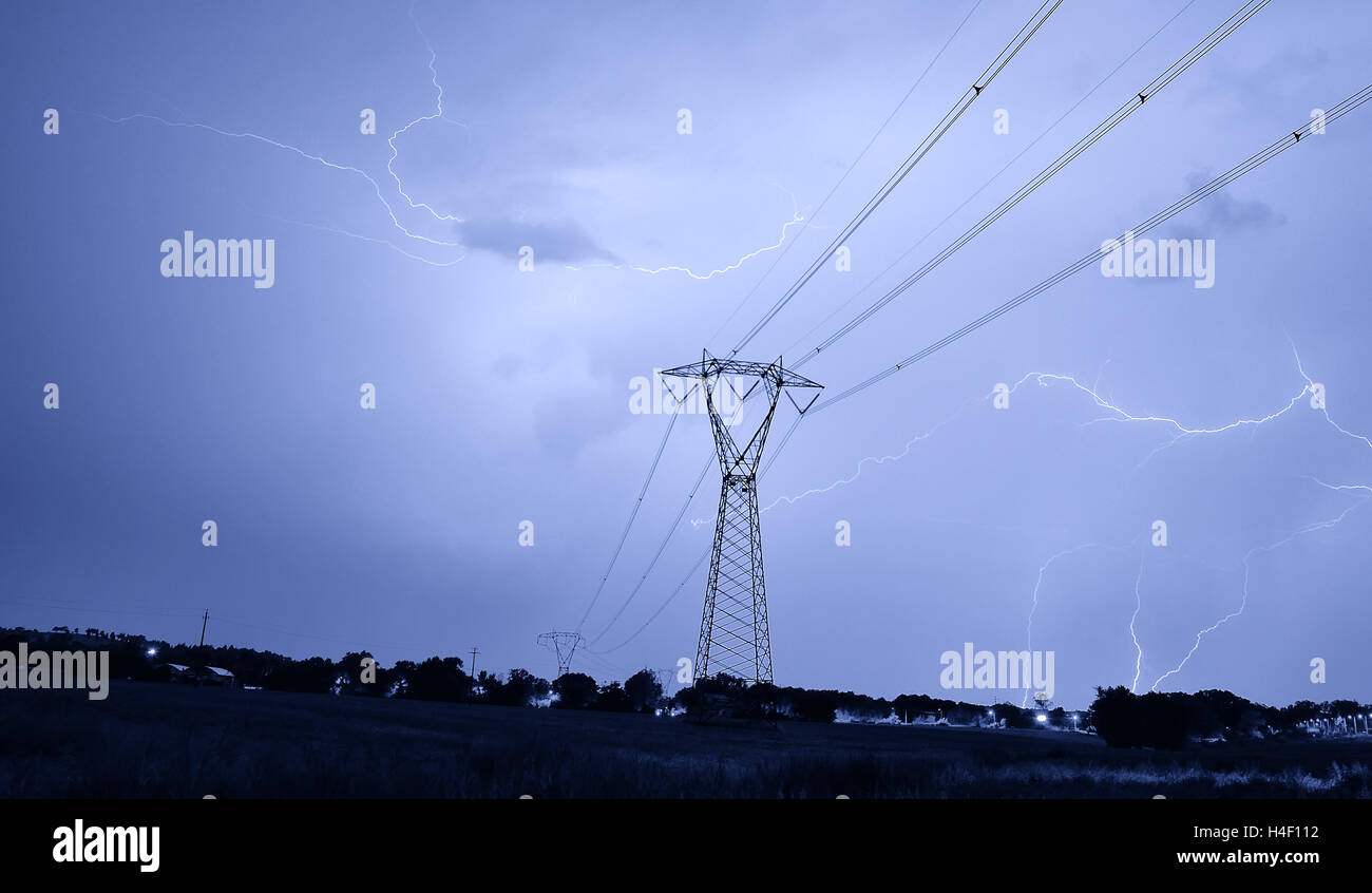 high voltage pylon with lightning in the sky in the night Stock Photo ...