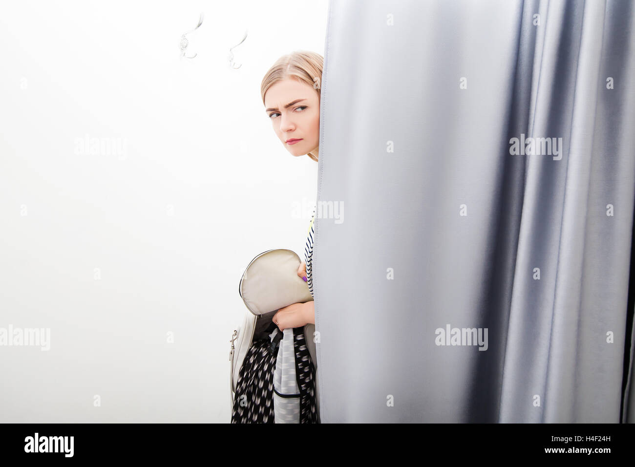 Woman stealing a dress Stock Photo - Alamy