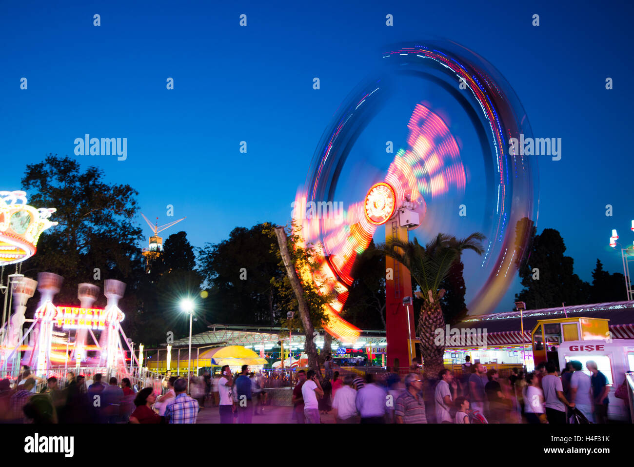 Amusement park and crowded people enjoying. Izmir international fair ...