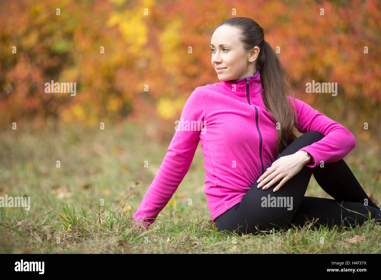 Autumn yoga: Ardha Matsyendrasana pose Stock Photo - Alamy