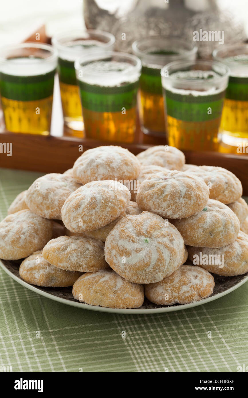 Dish with Moroccan festive homemade ghoriba cookies close up and tea ...