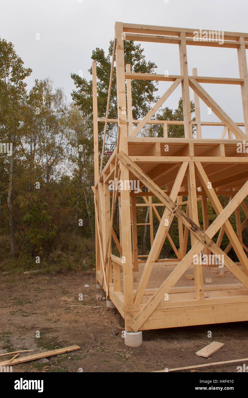 Drizzly autumn day at the construction site. Construction of a wooden ...