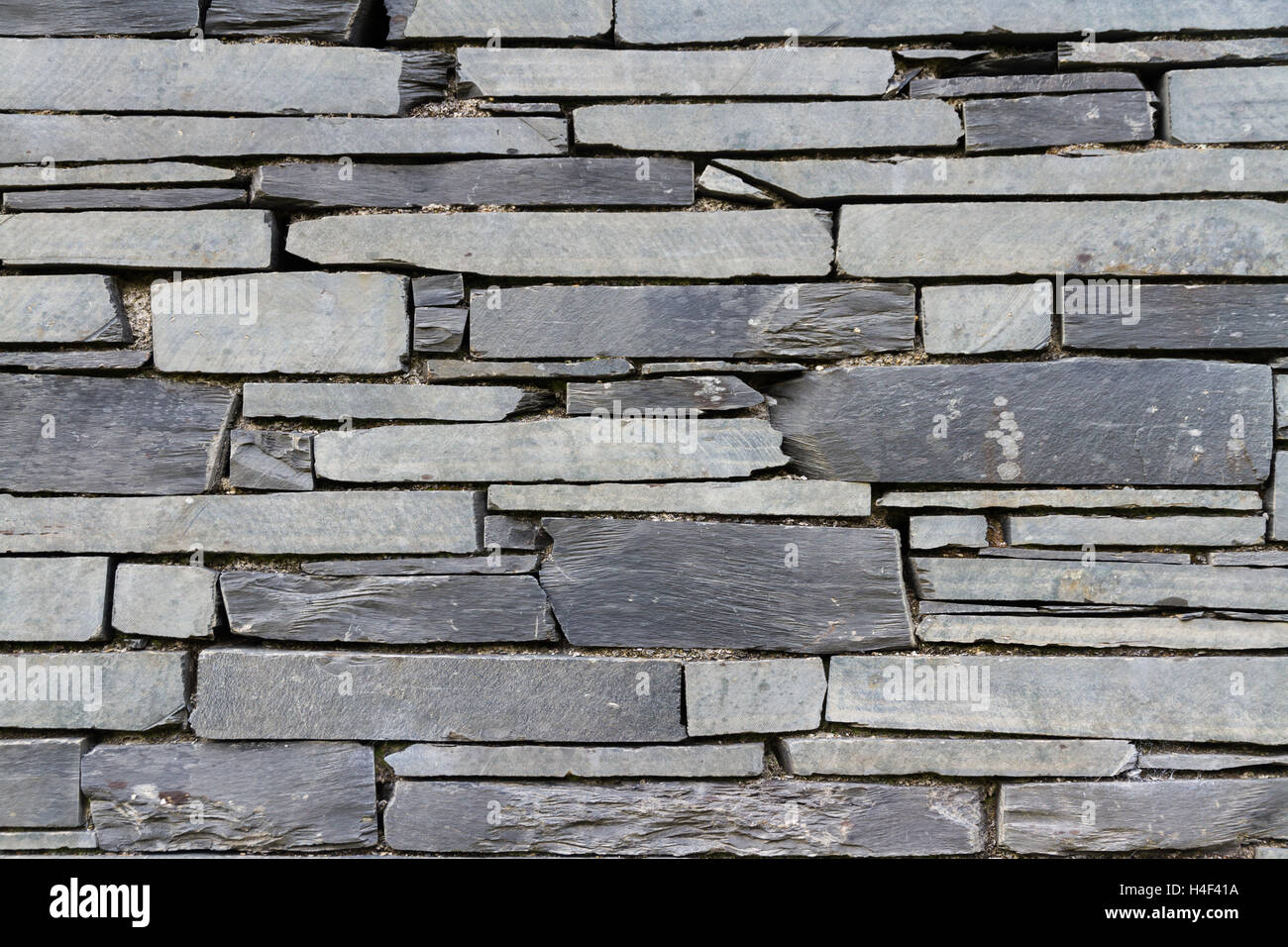 Dry stone slate wall making background texture Stock Photo - Alamy