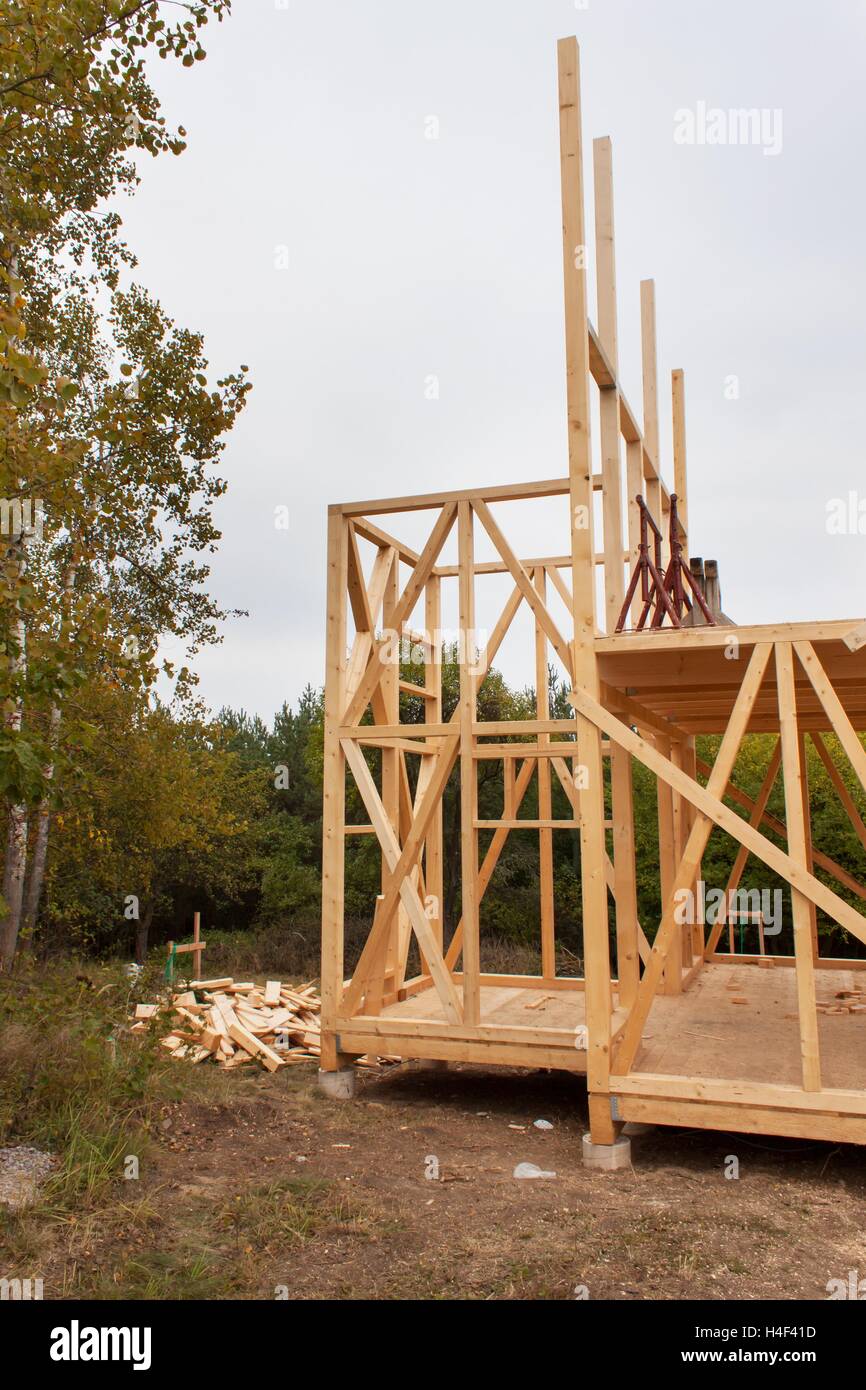 Drizzly autumn day at the construction site. Construction of a wooden ...