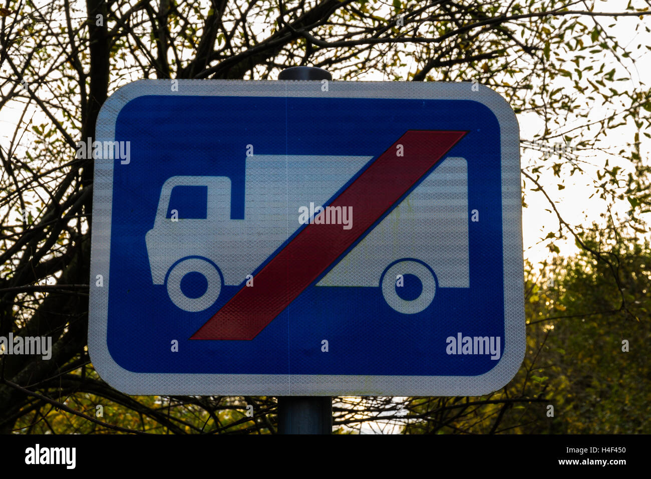 Blue sign showing lorry or HGV with red line through it to warn that ...