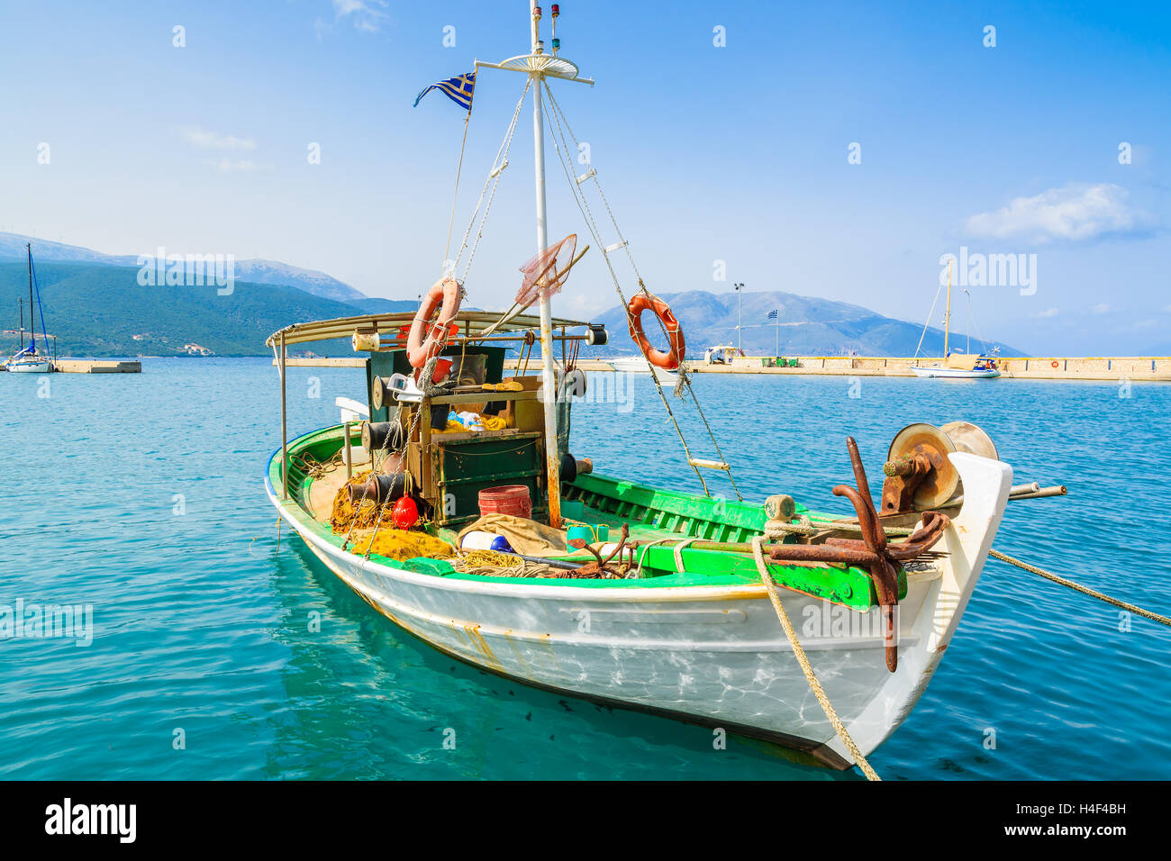 Traditional colorful Greek fishing boat in port of Sami village ...