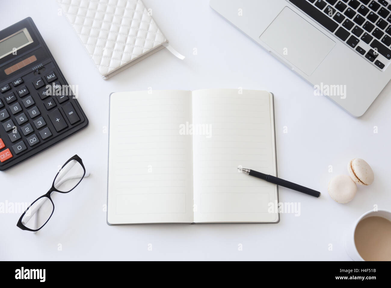 Top view of a working desk with open notebook Stock Photo - Alamy