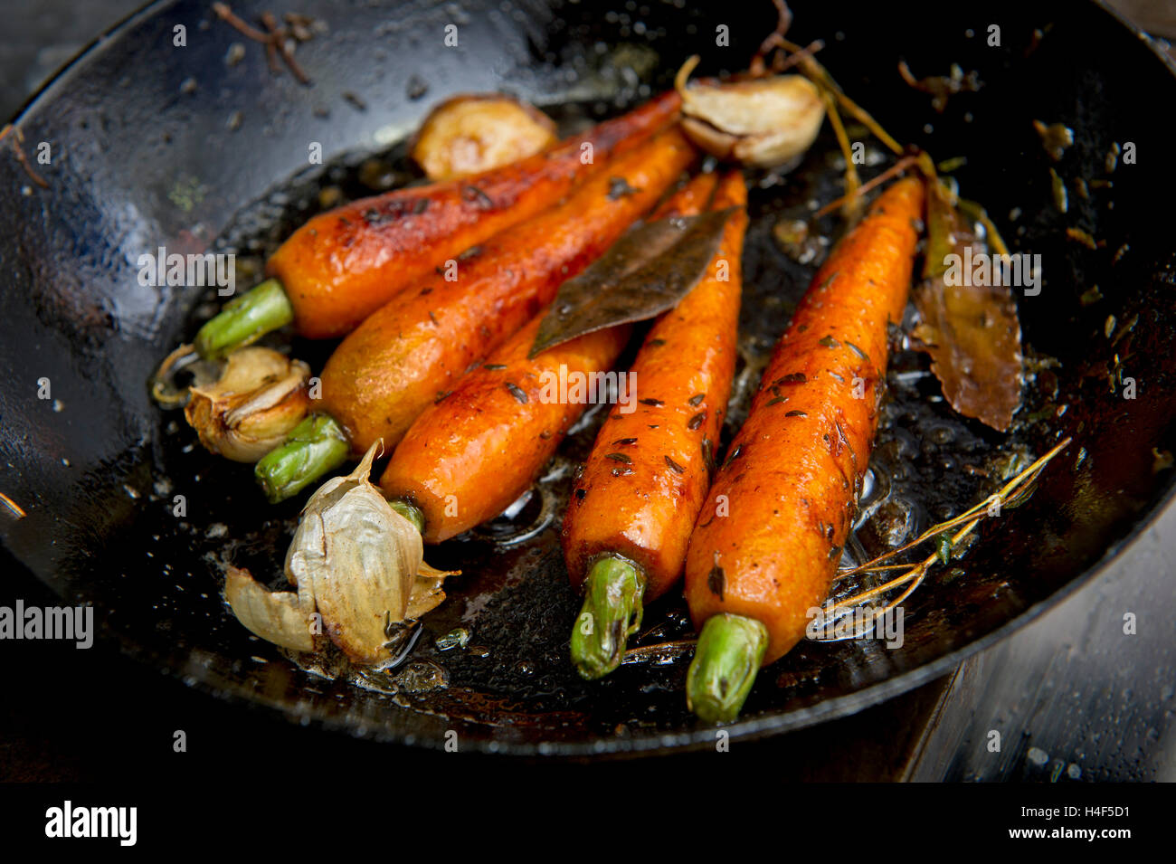 carrots cooking in a shallow frying pan Stock Photo - Alamy
