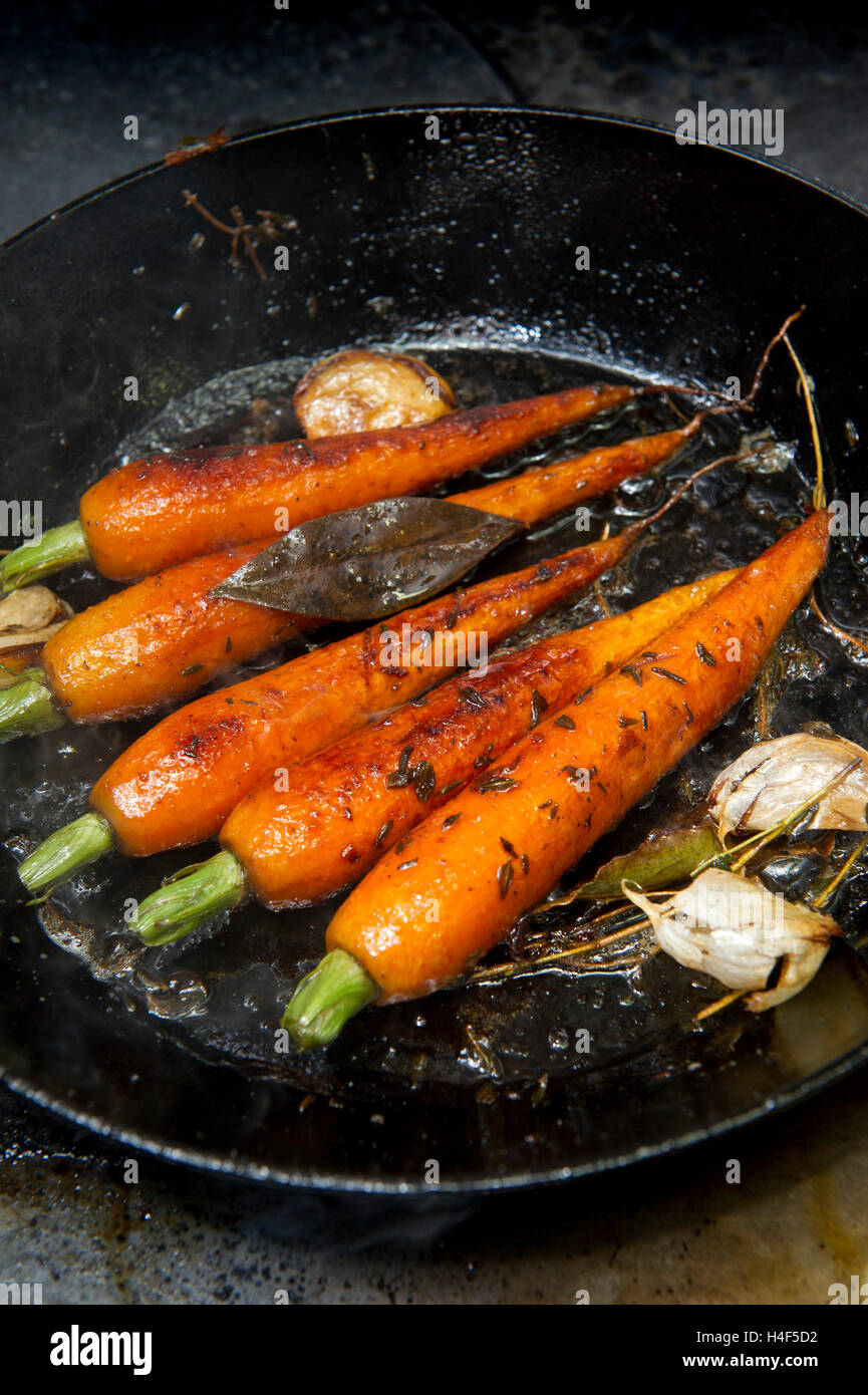 carrots cooking in a shallow frying pan Stock Photo - Alamy