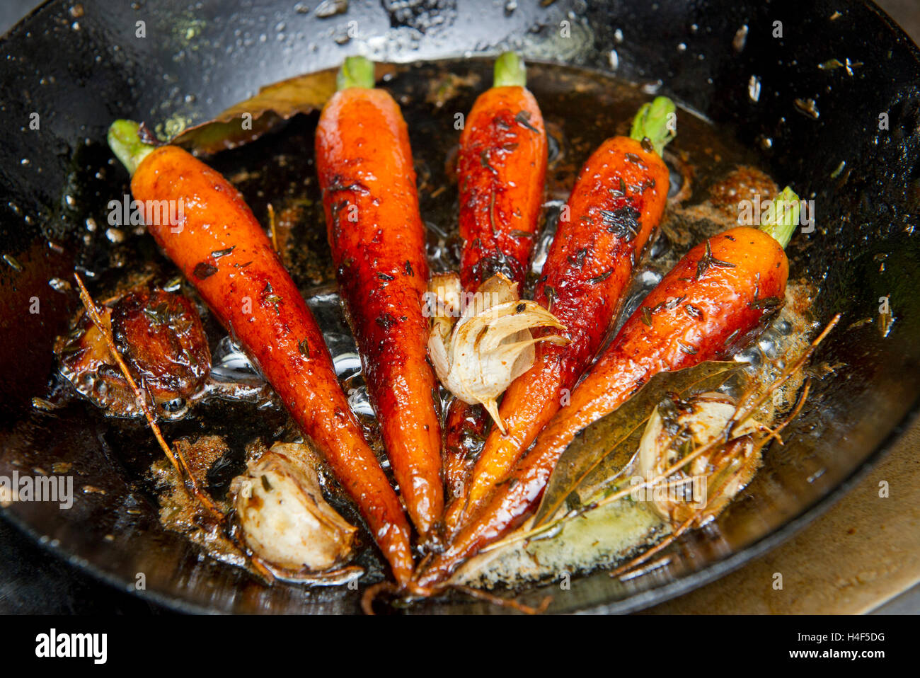 carrots cooking in a shallow frying pan Stock Photo - Alamy