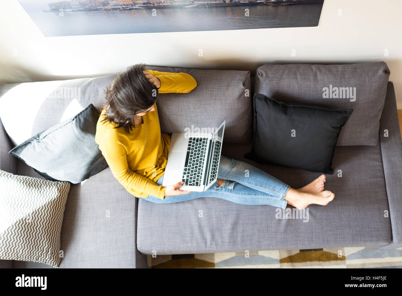 Beautiful woman relaxing with a computer Stock Photo - Alamy