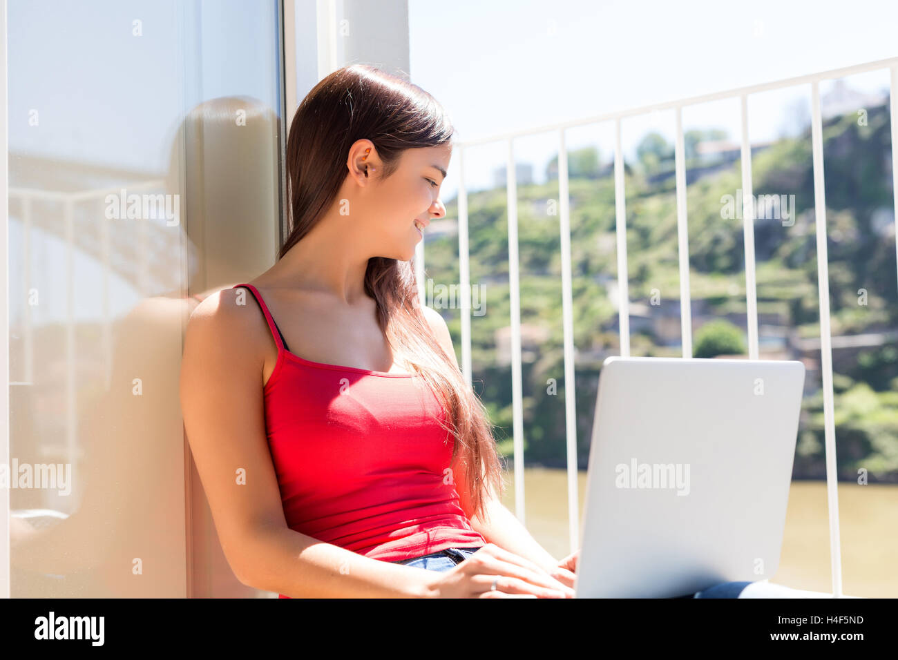 Beautiful woman relaxing with a computer Stock Photo - Alamy