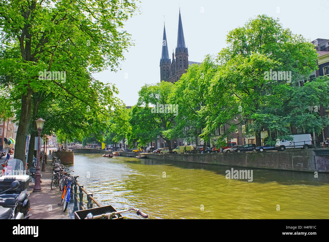 One of the main canals of Amsterdam Singel with De Krijtberg Kerk ...