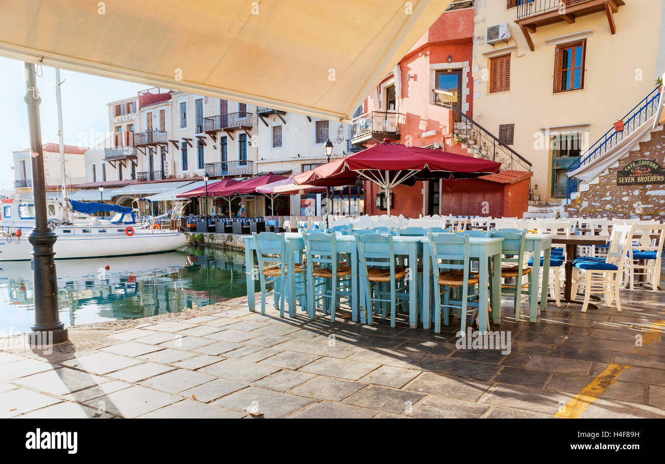 The wooden chairs and tables of the outdoor cafes and taverns in the ...