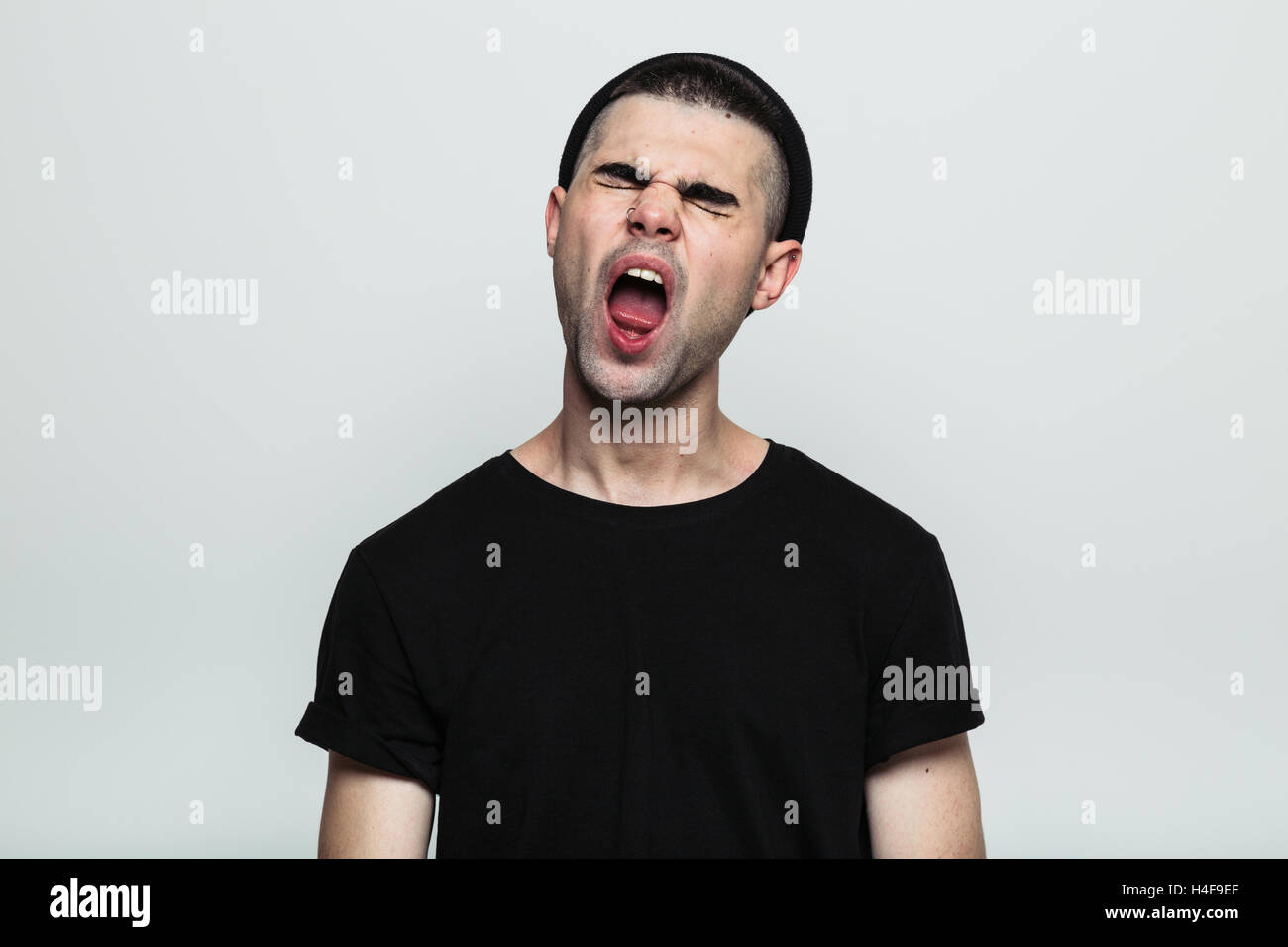 Portrait of man yawning Stock Photo - Alamy