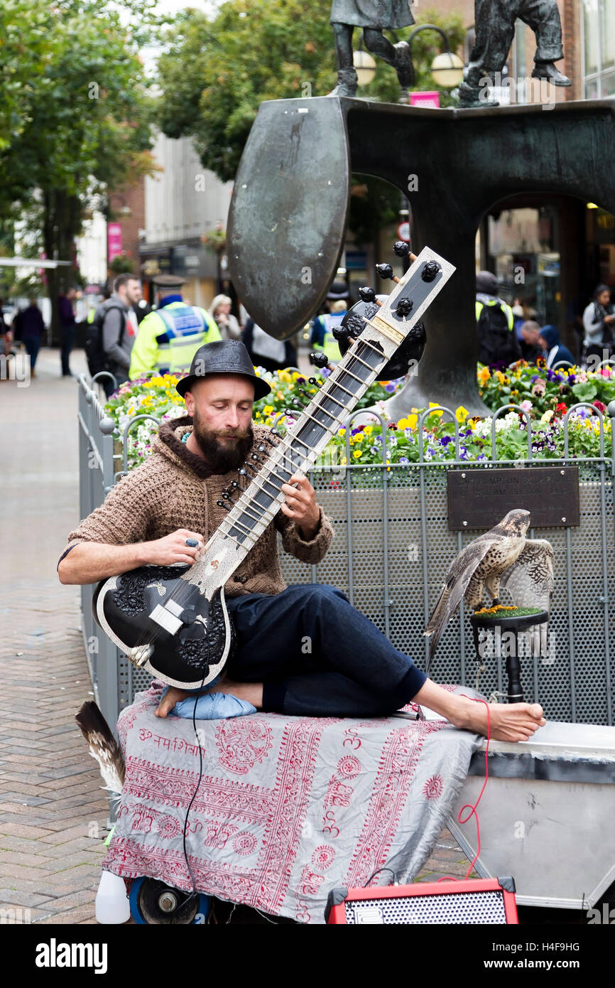 Buskers playing a Grand Pro Tun Sitar a Indian instrument in Abington ...