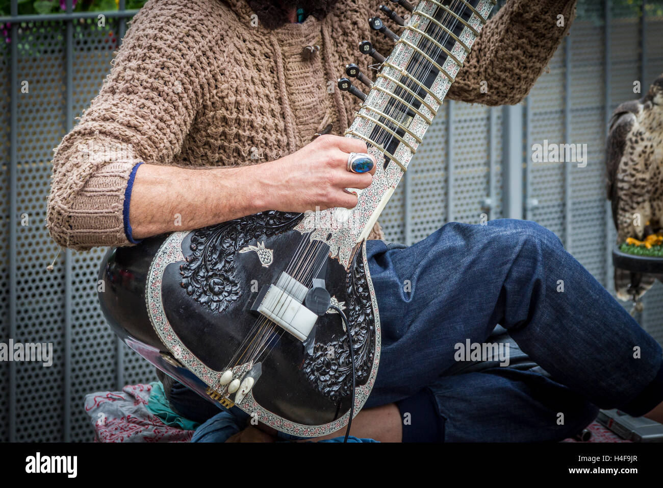 Buskers playing a Grand Pro Tun Sitar a Indian instrument in Abington ...