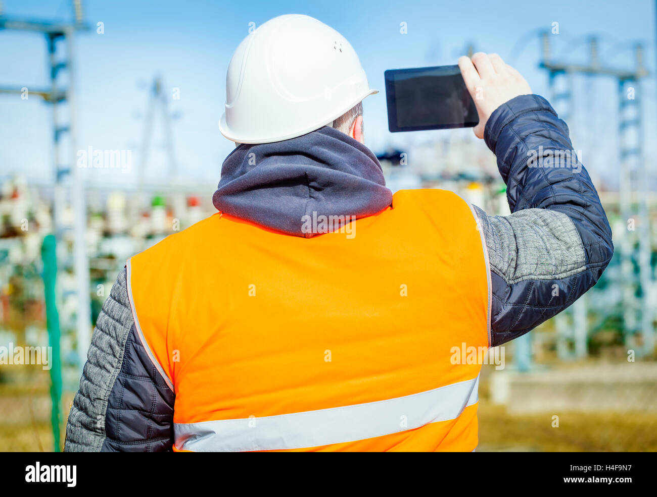 Electrical engineer filmed with tablet PC Stock Photo - Alamy