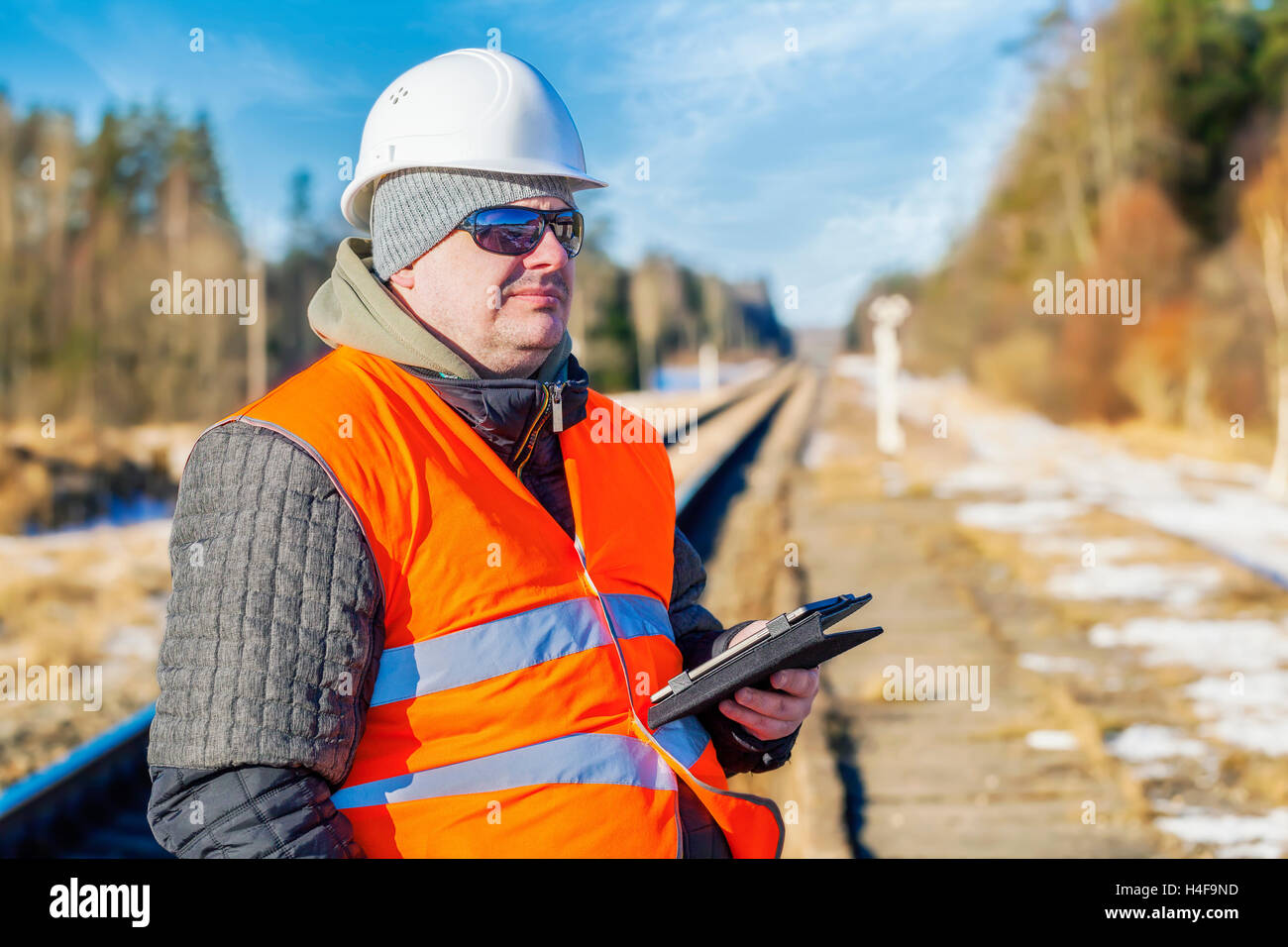 Railway employee with tablet PC on the railway Stock Photo - Alamy