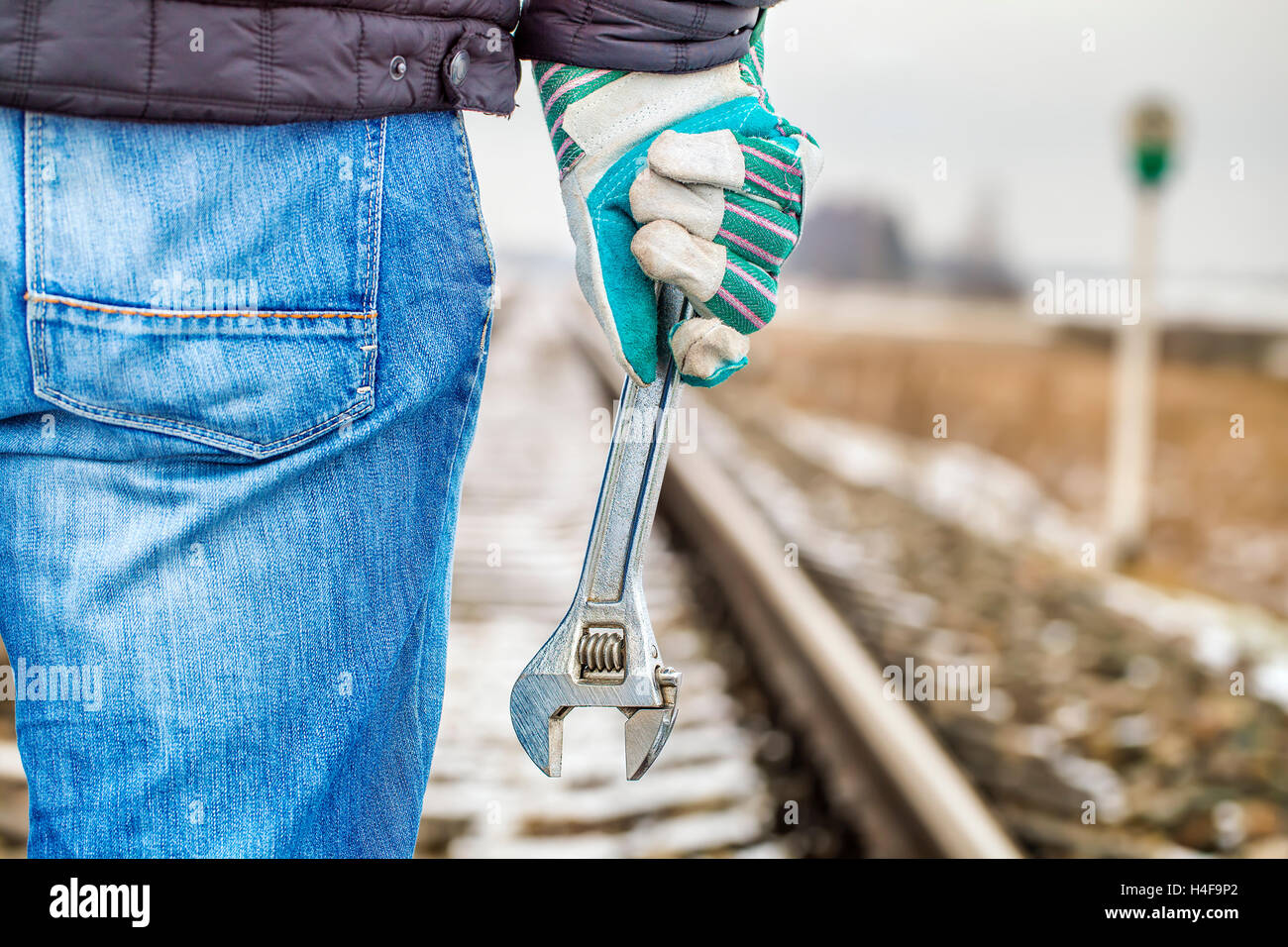 Man with adjustable wrench on the railroad Stock Photo - Alamy