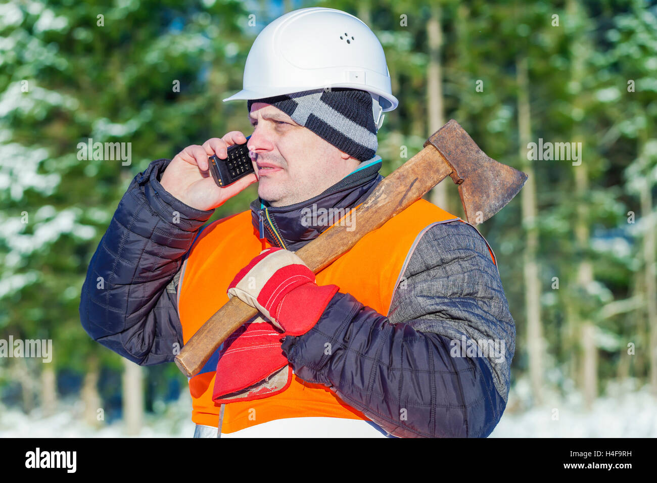 Lumberjack in the forest in winter with an ax Stock Photo - Alamy