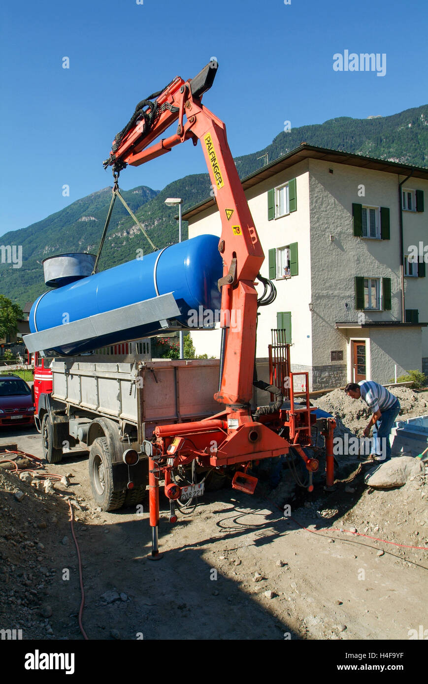 Biasca, Switzewrland - workers while laying on the ground of a gas tank ...