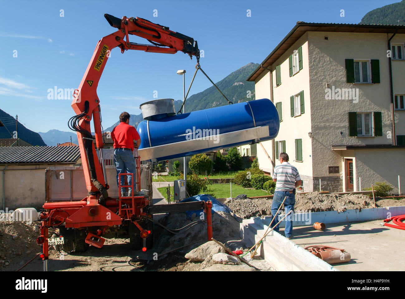 Biasca, Switzewrland - workers while laying on the ground of a gas tank ...