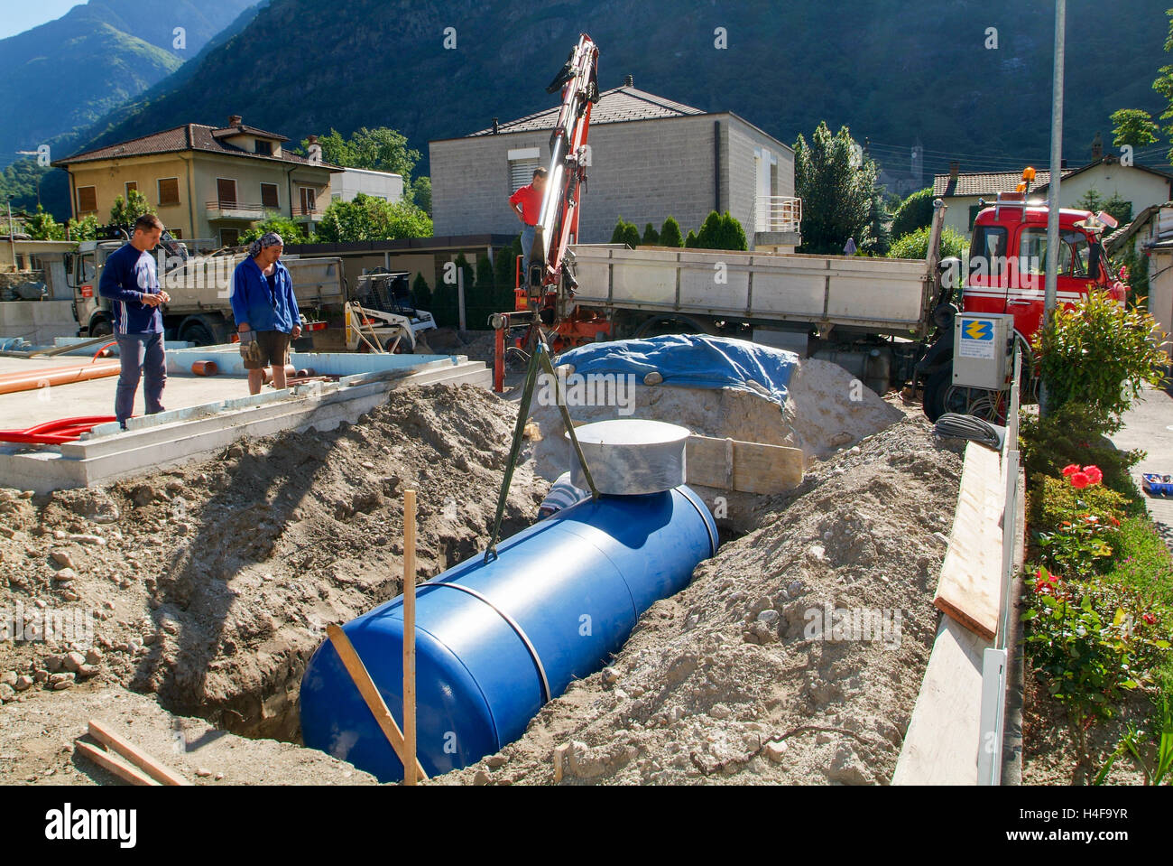 Biasca, Switzewrland - workers while laying on the ground of a gas tank ...