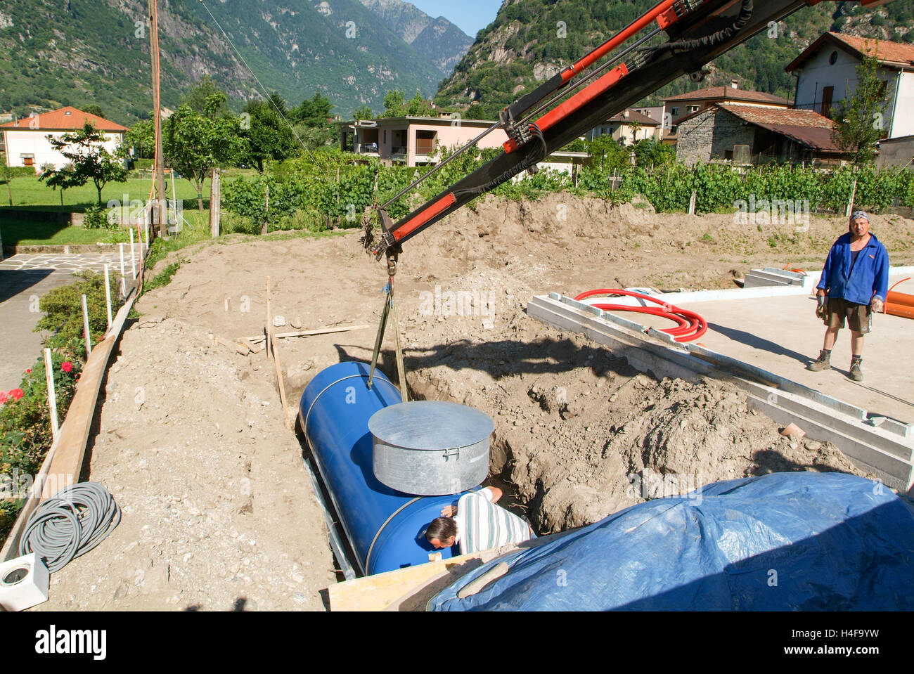 Biasca, Switzewrland - workers while laying on the ground of a gas tank ...