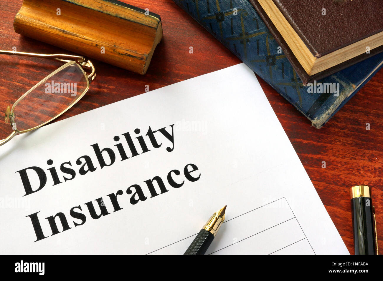 Disability insurance on a office table with a pen Stock Photo - Alamy
