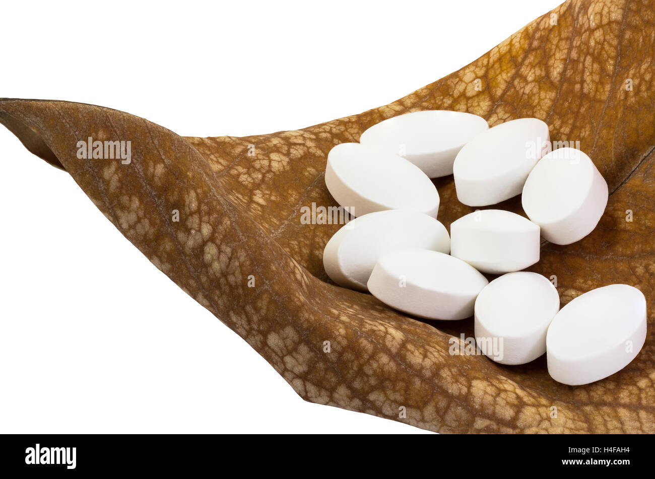 White pills on fresh green leaves, drugs and nature concept Stock Photo ...