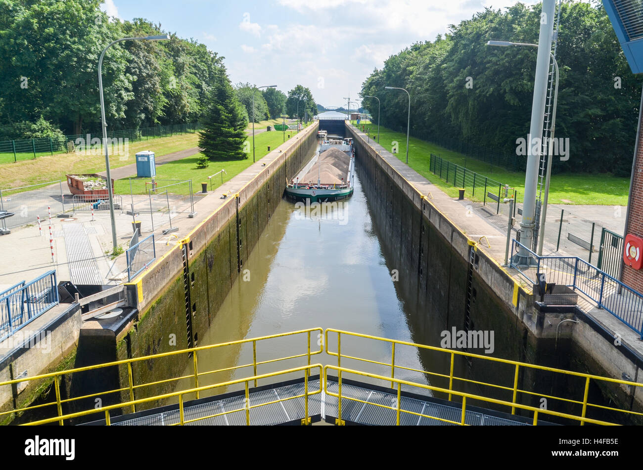 Barge passing a lock on a canal of the Weser river in Germany Stock ...