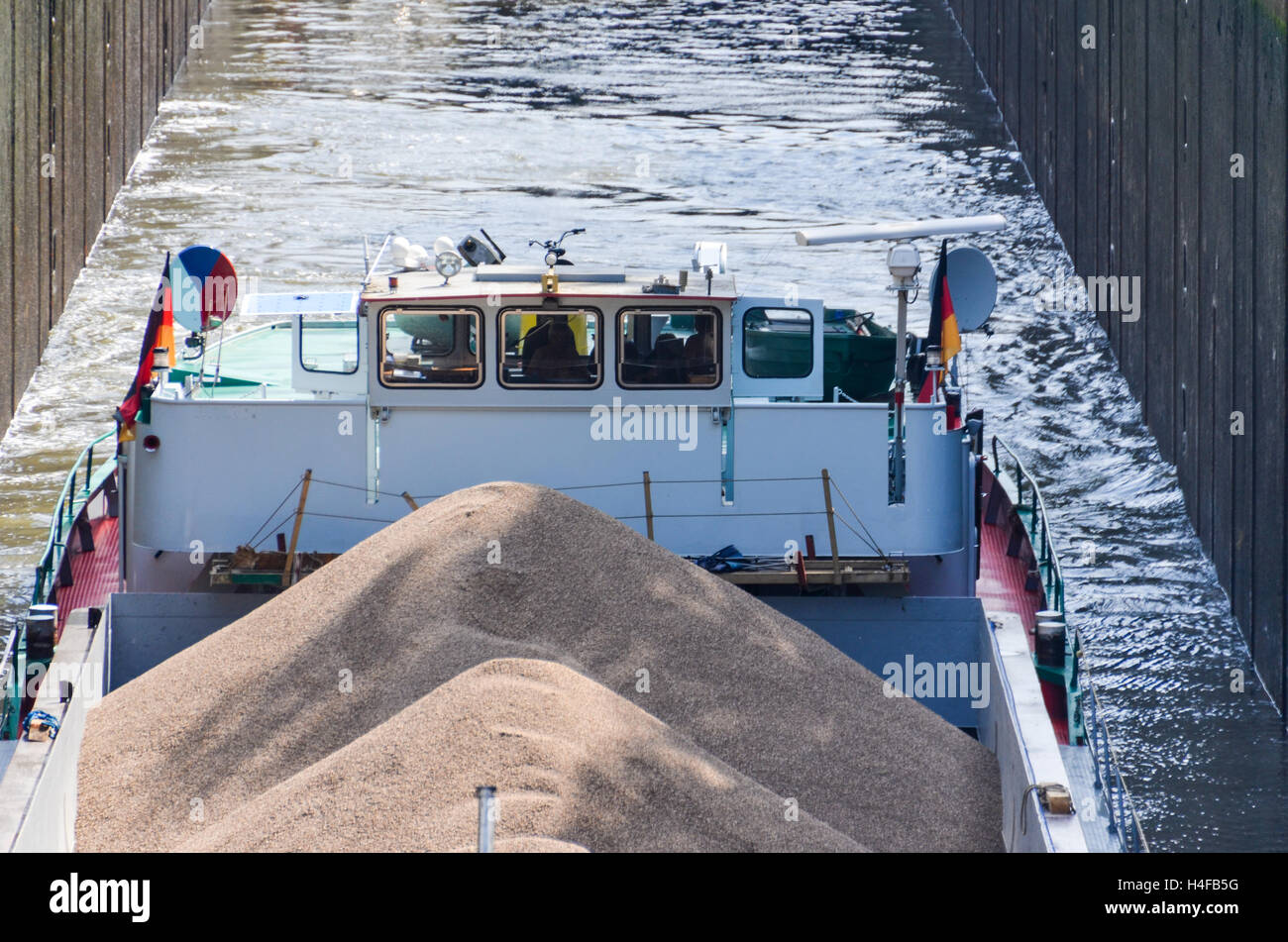 Barge passing a lock on a canal of the Weser river in Germany Stock ...