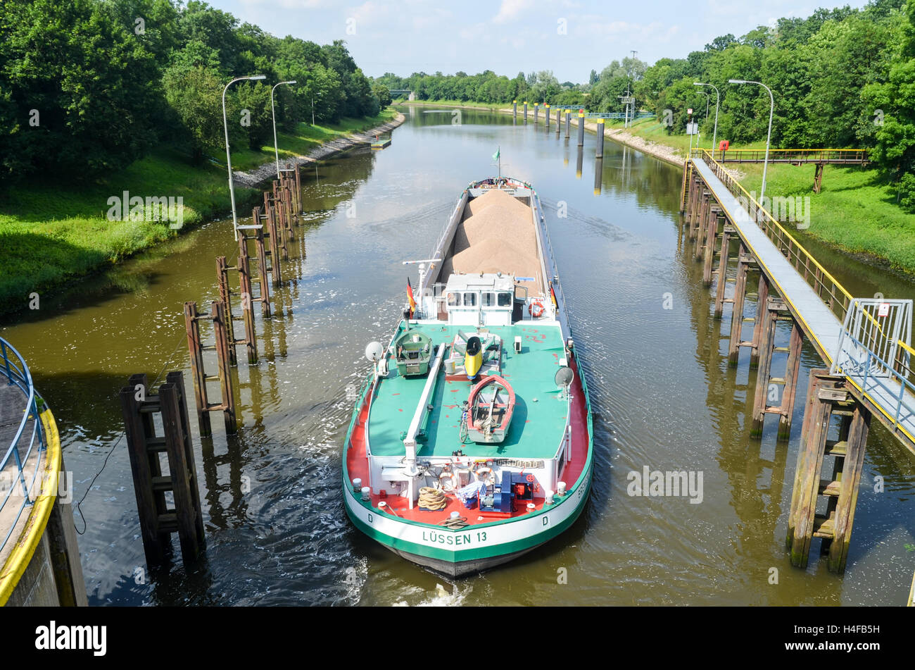 Barge passing a lock on a canal of the Weser river in Germany Stock ...