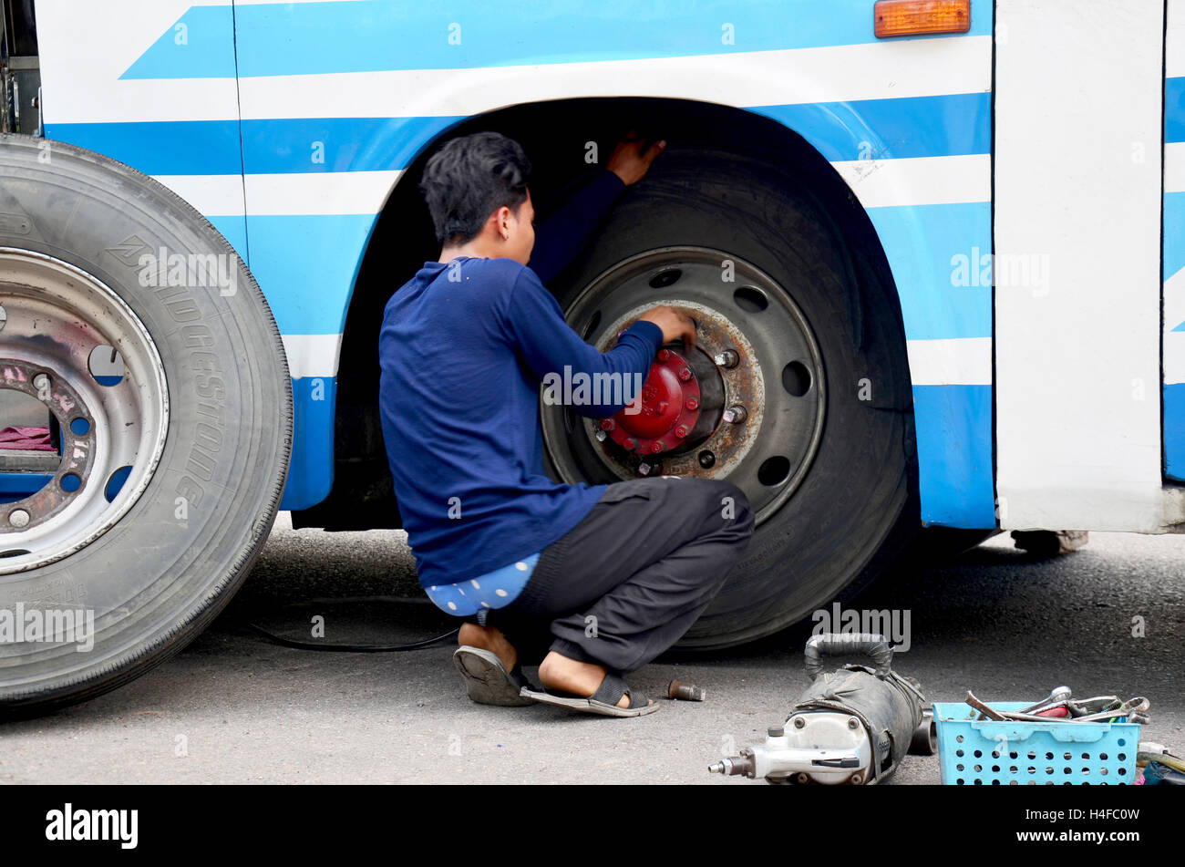 Thai mechanic people repairing and fix change wheel tire of bus broken ...