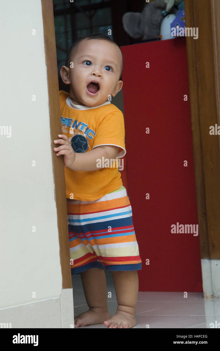 a kids, toddler, learning to walk, with happy face Stock Photo - Alamy
