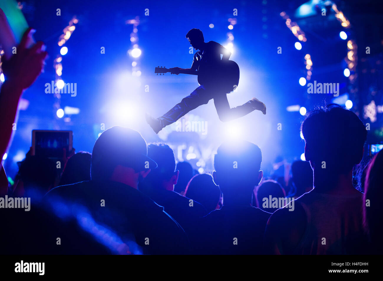 Singer singing on concert stage with ray of illuminated, Singer and ...